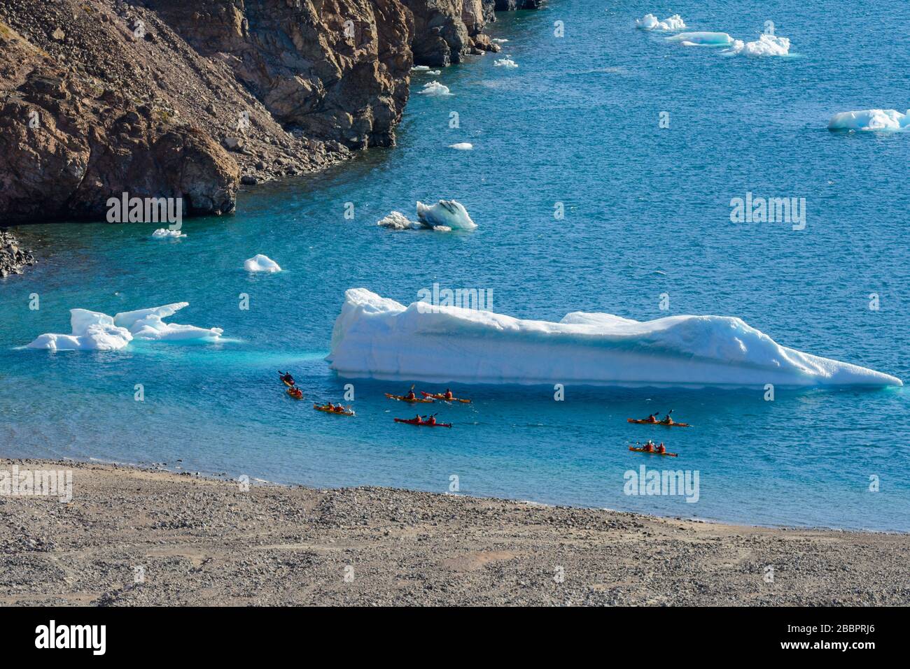 Kayaking in Arctic sea near iceberg Stock Photo - Alamy