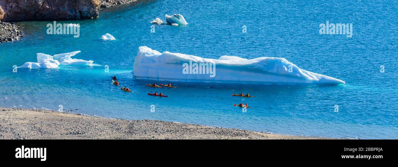 Kayaking in Arctic sea near iceberg Stock Photo - Alamy