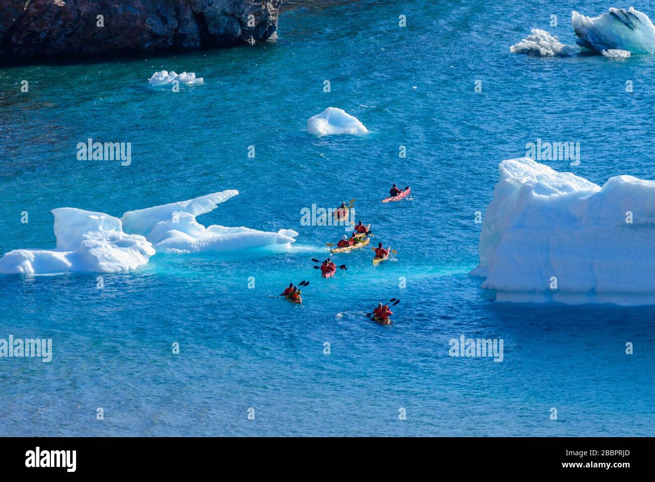 Kayaking in Arctic sea near iceberg Stock Photo - Alamy