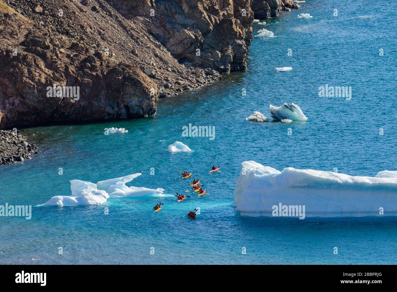 Kayaking in Arctic sea near iceberg Stock Photo - Alamy