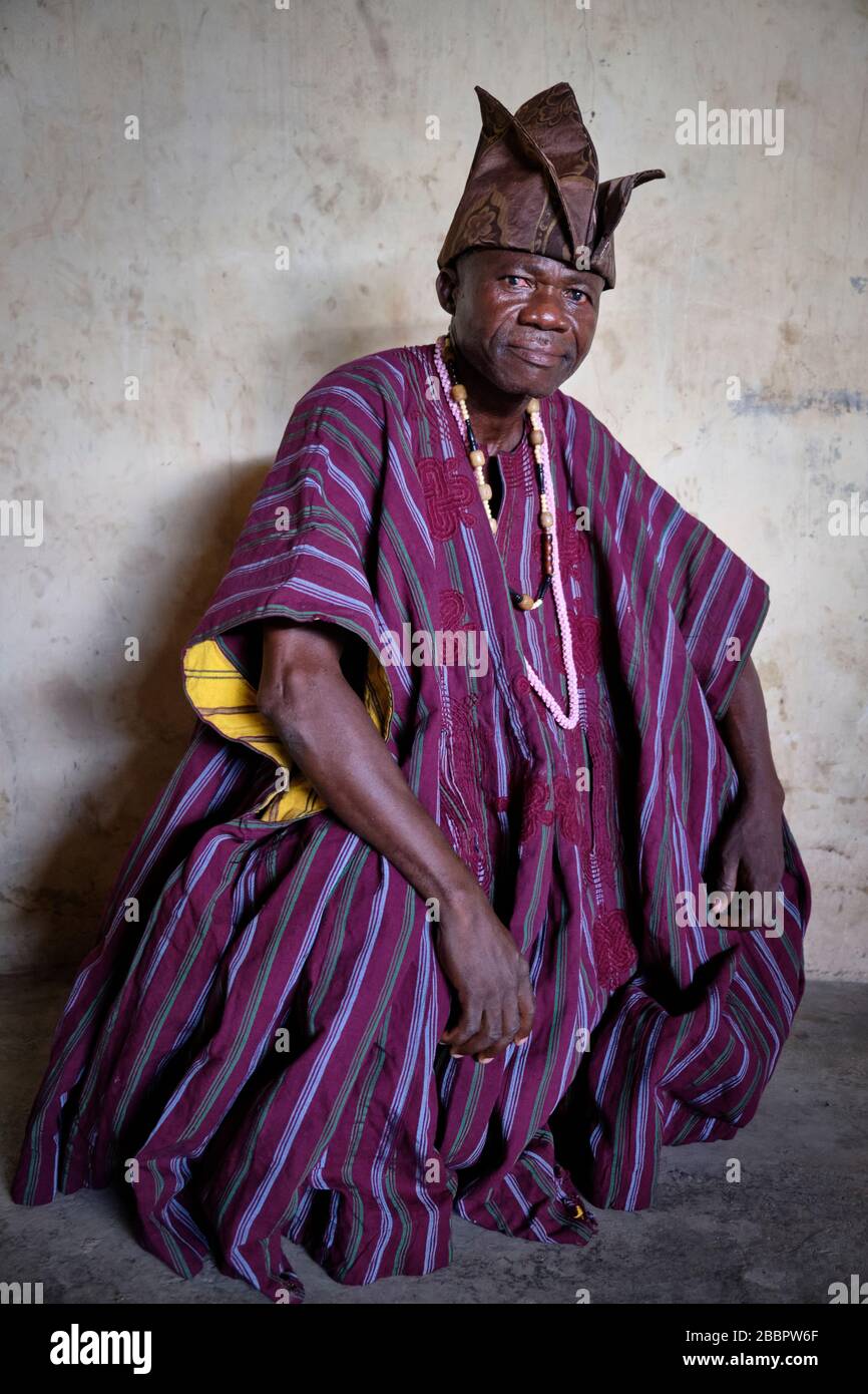 Portrait of a Yoruba priest with traditional amulets, robes and ...