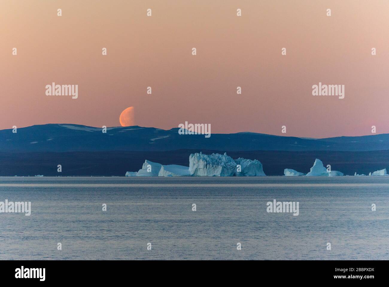Beautiful moonrise in Greenland. Iceberg at sea Stock Photo - Alamy