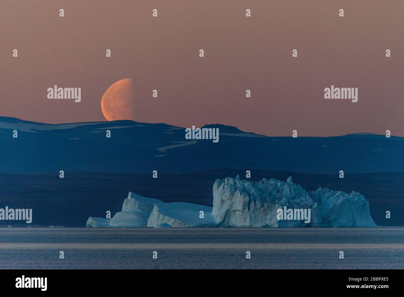Beautiful moonrise in Greenland. Iceberg at sea Stock Photo - Alamy