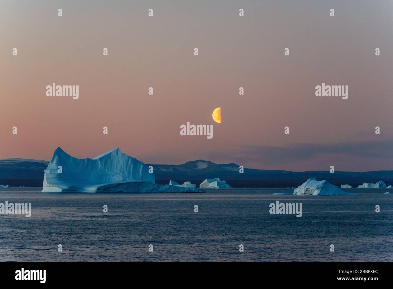 Beautiful moonrise in Greenland. Iceberg at sea Stock Photo - Alamy