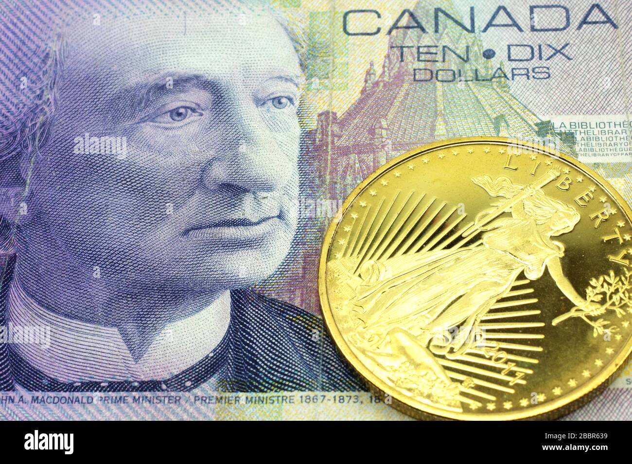 A Macro Image Of A Purple Canadian Ten Dollar Bill With A Gold Coin a-macro-image-of-a-purple-canadian-ten-dollar-bill-with-a-gold-coin