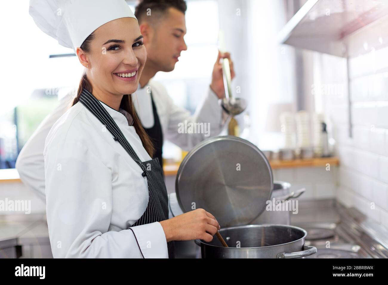 Female and male chefs in kitchen Stock Photo - Alamy