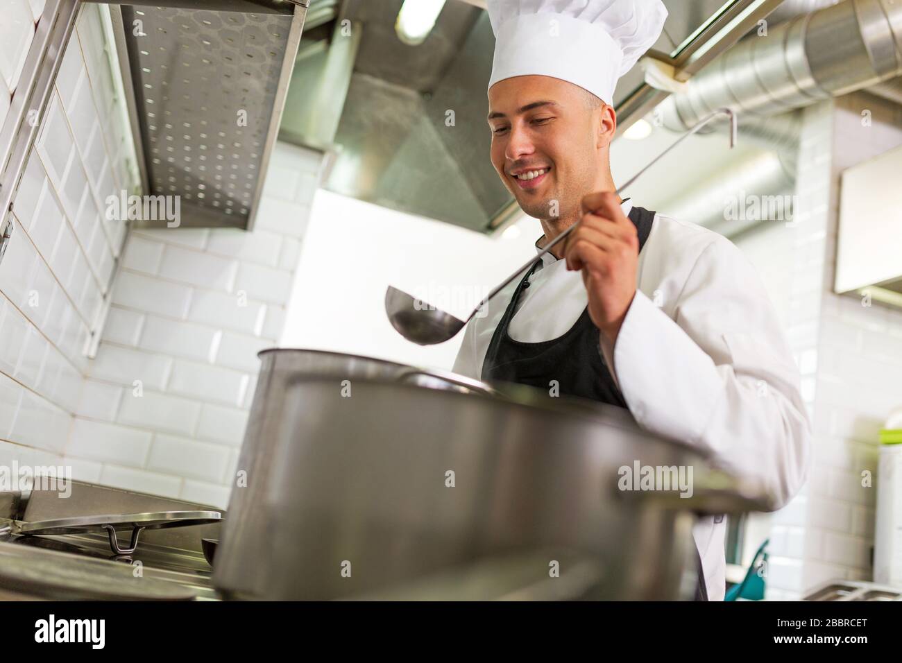 Professional chef in industrial kitchen Stock Photo - Alamy