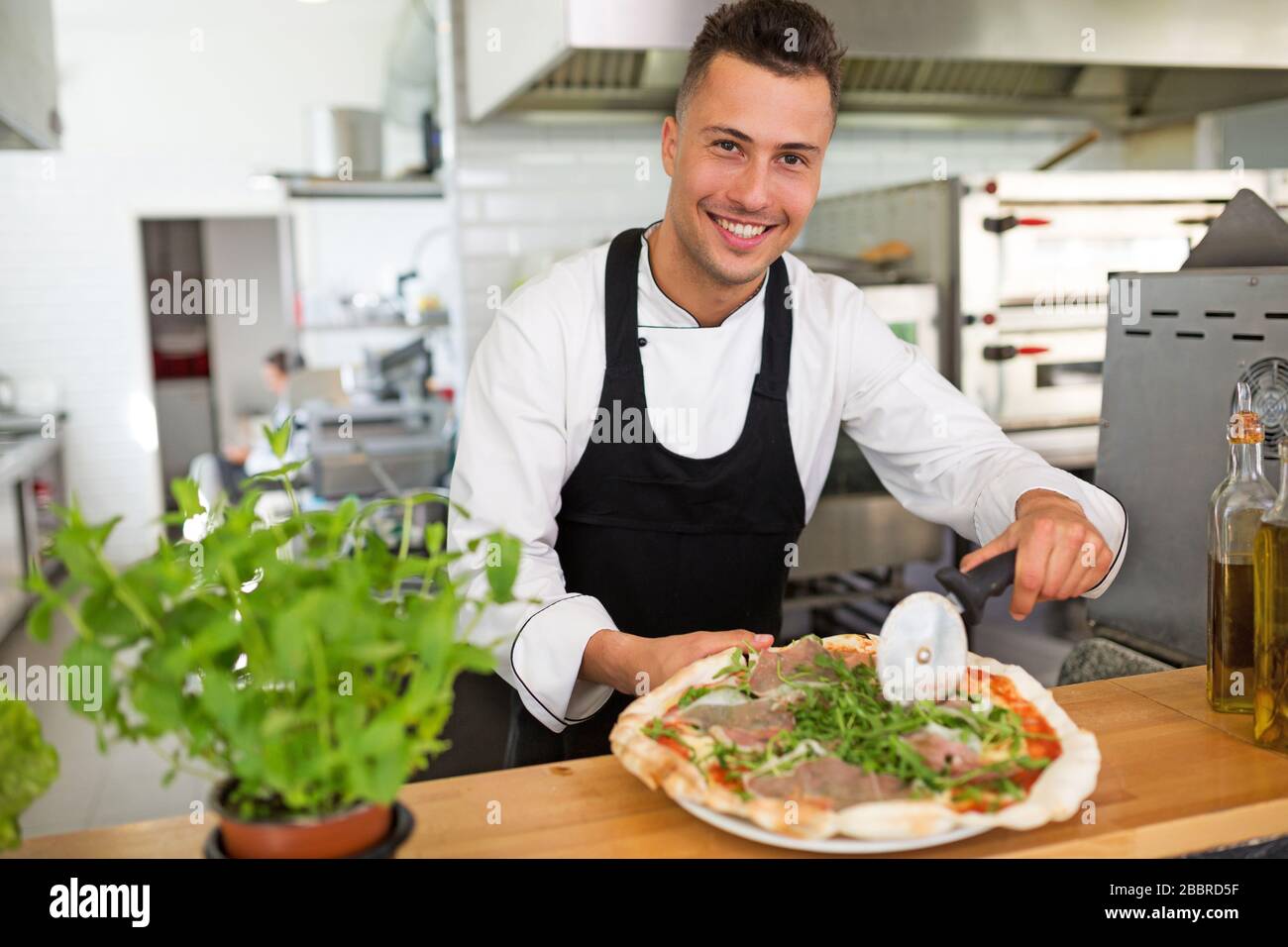 Professional chef in industrial kitchen Stock Photo - Alamy