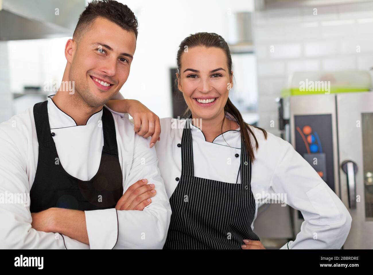 Female and male chefs in kitchen Stock Photo - Alamy