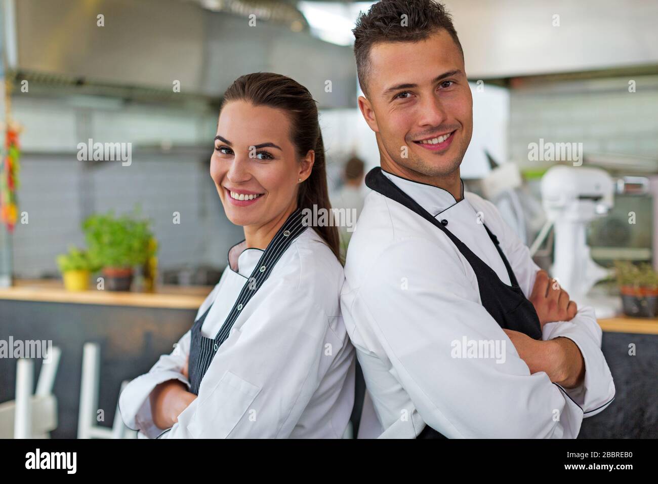 Female and male chefs in kitchen Stock Photo - Alamy