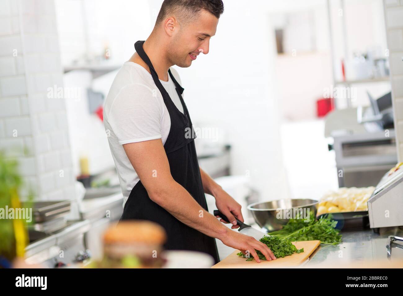 Professional chef in industrial kitchen Stock Photo - Alamy
