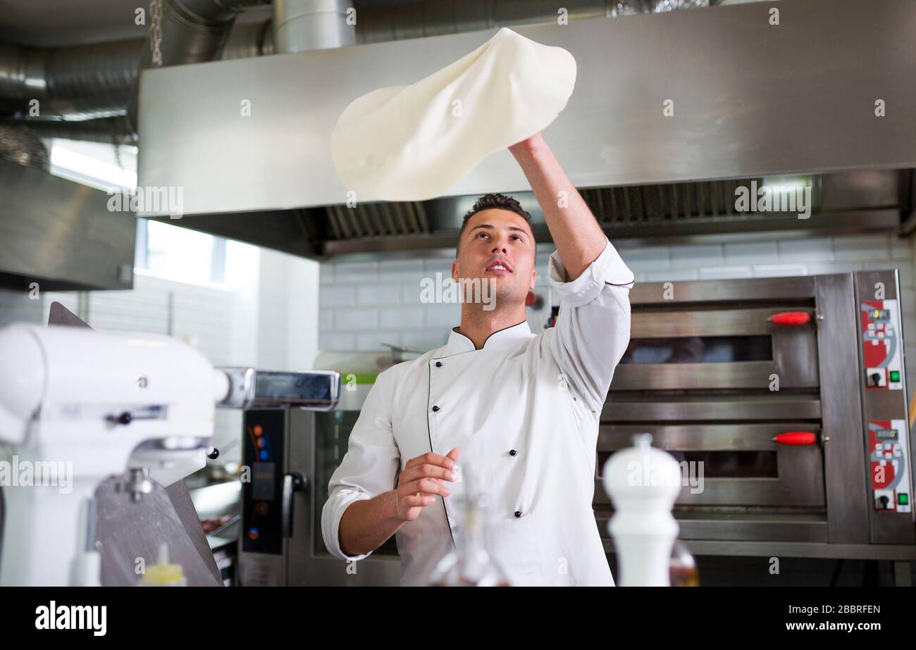 Professional chef in industrial kitchen Stock Photo - Alamy