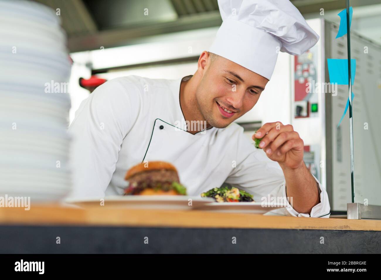 Professional chef in industrial kitchen Stock Photo - Alamy