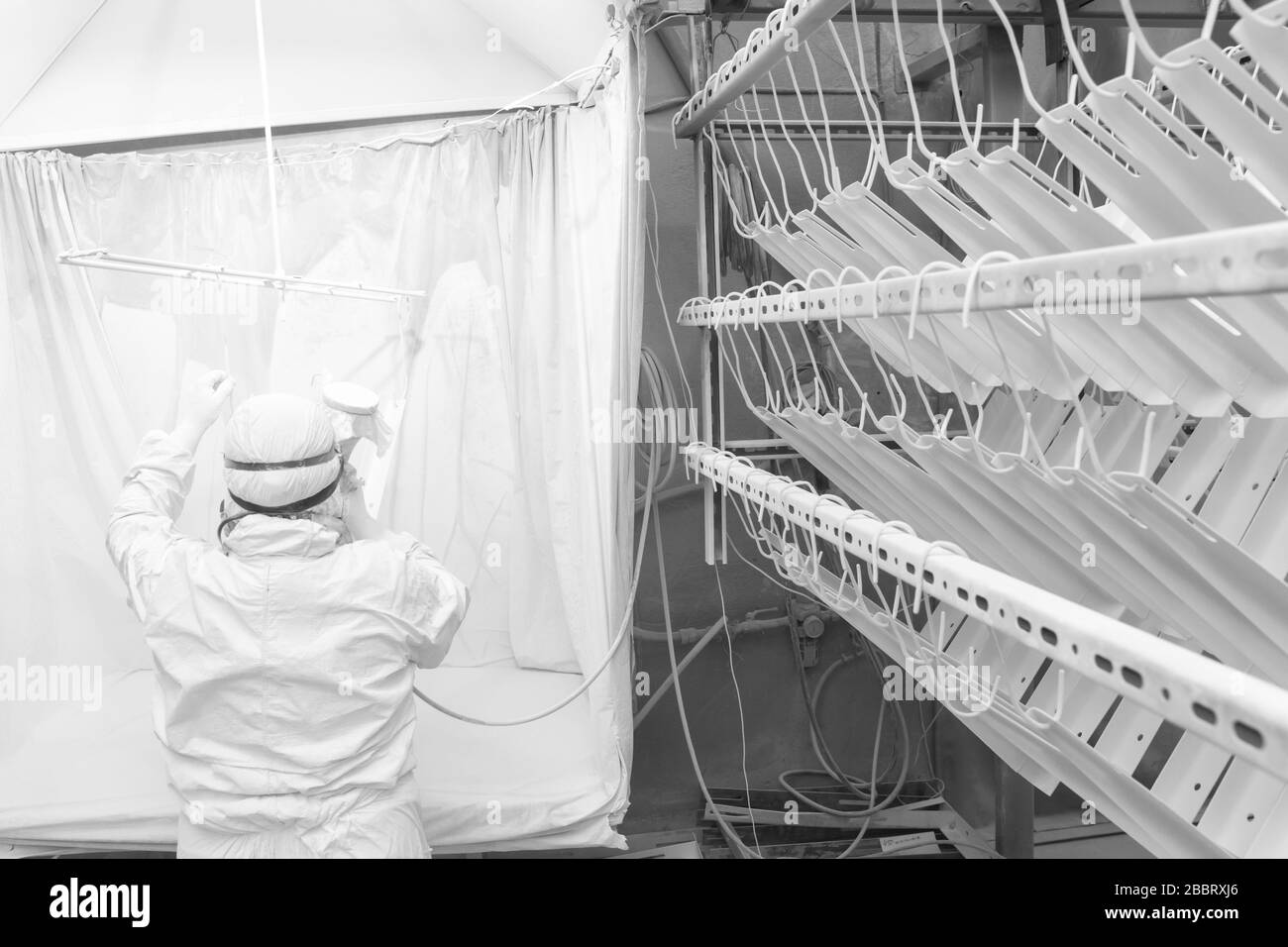 Powder coating of metal parts. Hand holding powder coating sprayer ...