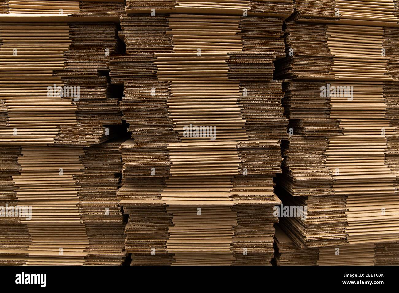 Supply of unassembled cardboard boxes in the warehouse. Stack of ...