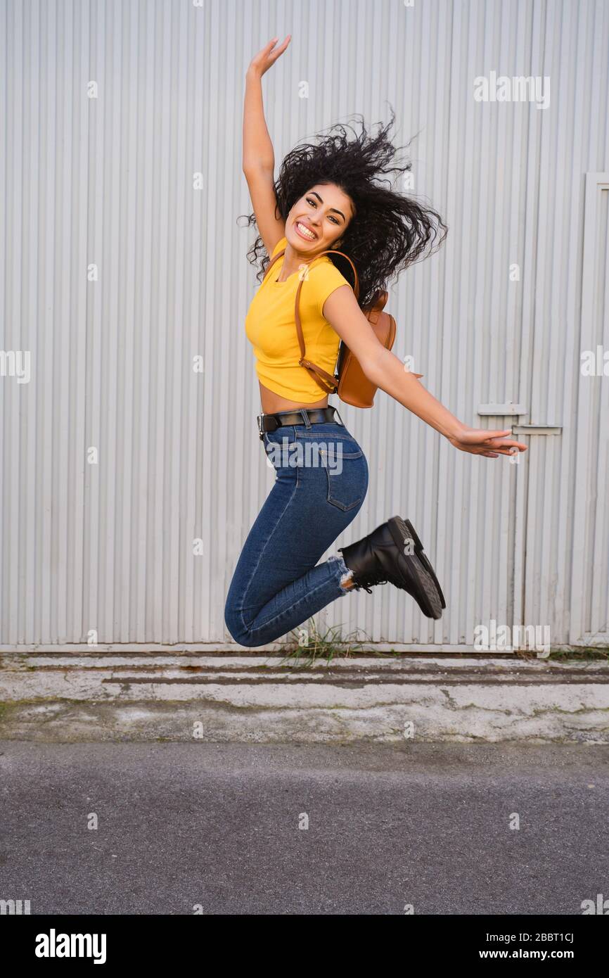 Atracctive girl jumping in the air on the street Stock Photo - Alamy