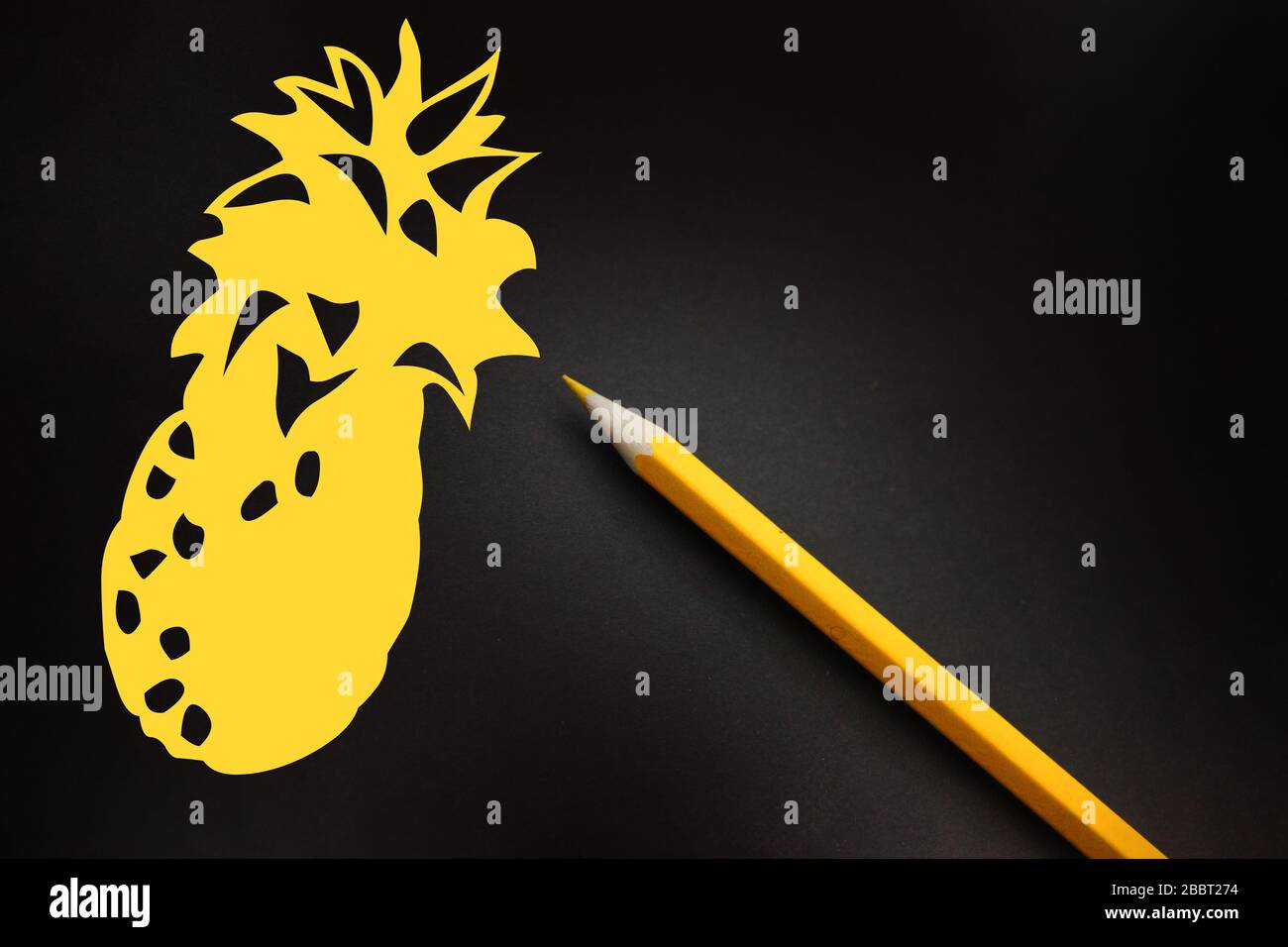 Yellow pinapple on black and yellow pencil. Go vegan healthy concept ...