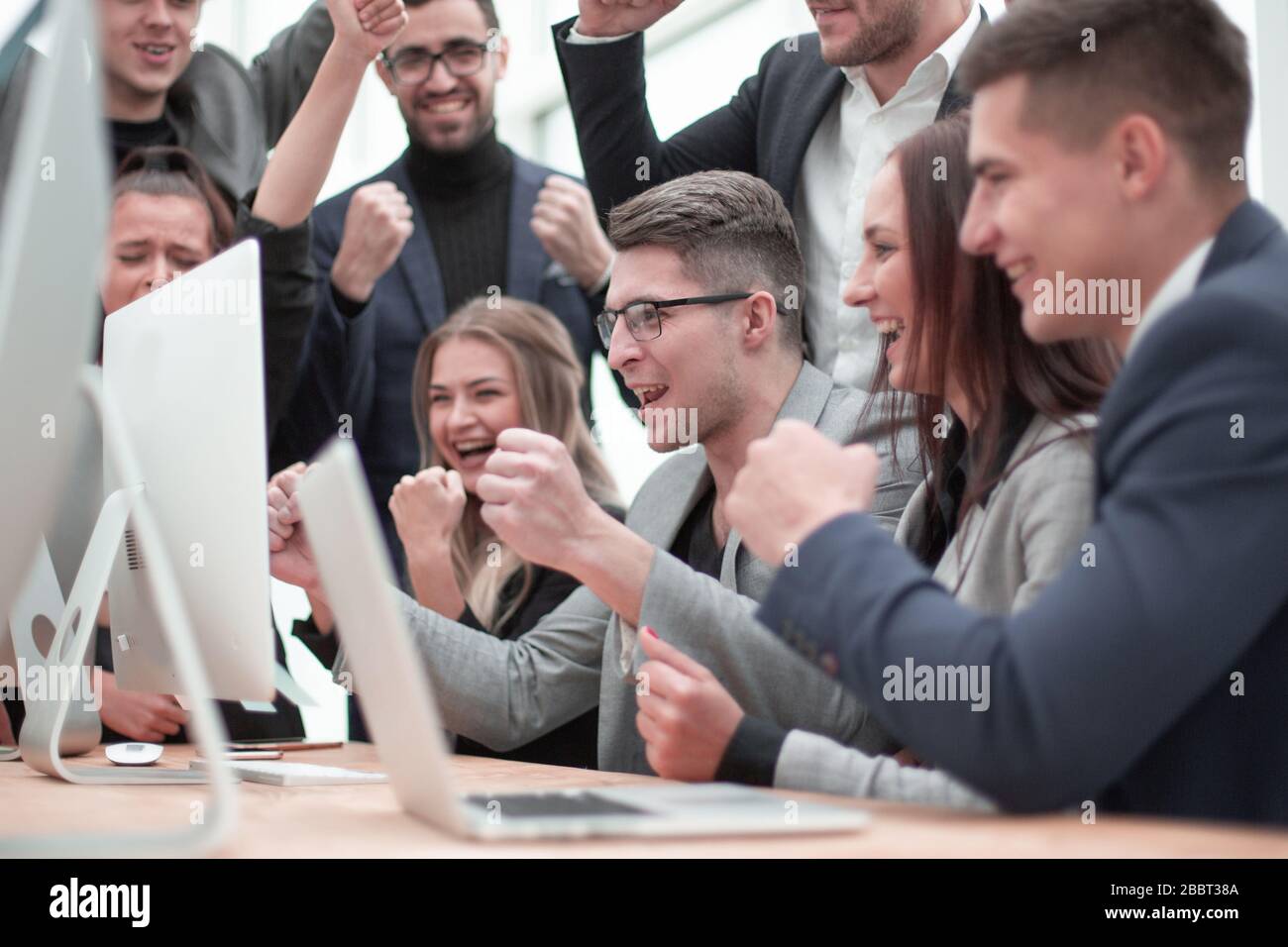 jubilant business team looking at the computer monitor Stock Photo - Alamy