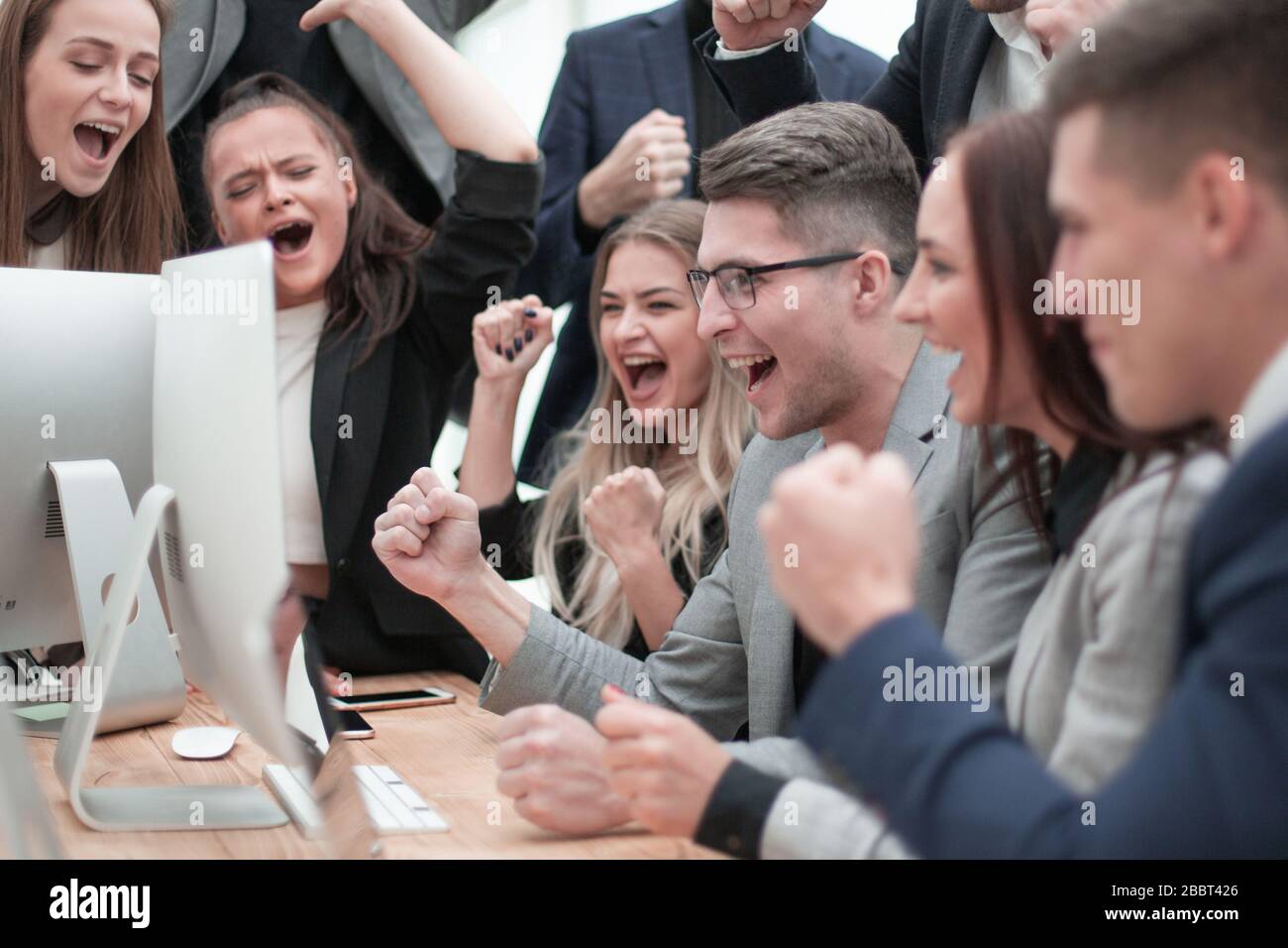 happy business team cheering near the desktop Stock Photo - Alamy