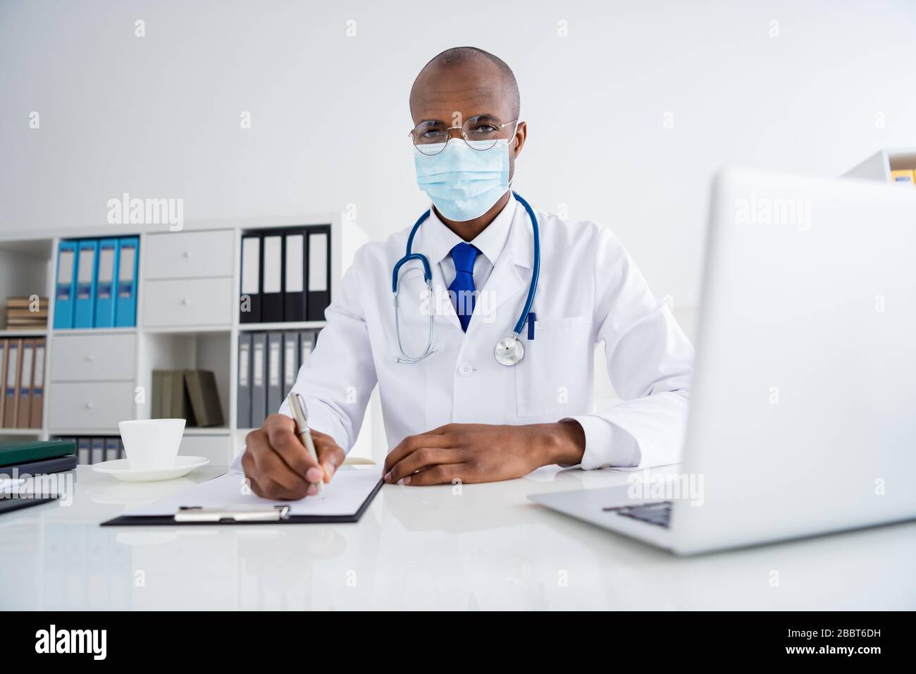 Doctor writing prescription mask hi-res stock photography and images ...