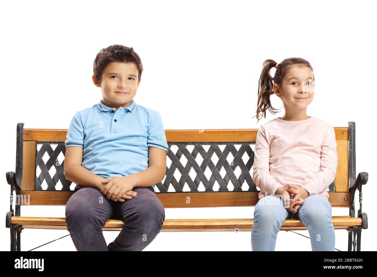 Children sitting on a bench and smiling isolated on white background ...