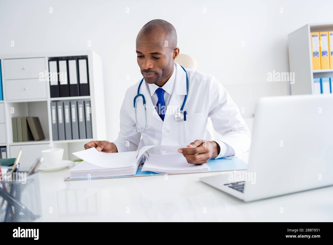 Photo of family doc dark skin successful professional guy write listing ...