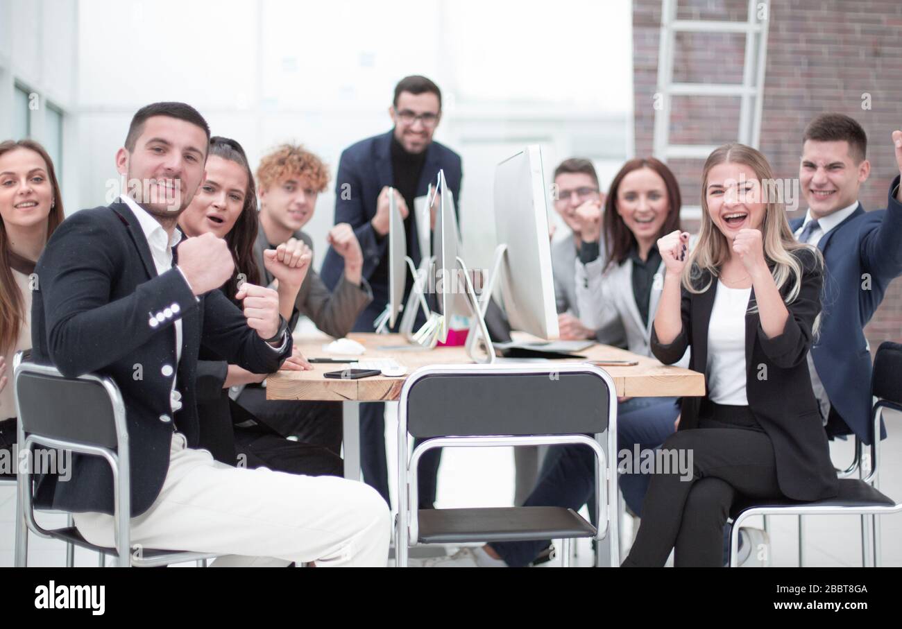 large group of employees sitting at office Desk Stock Photo - Alamy