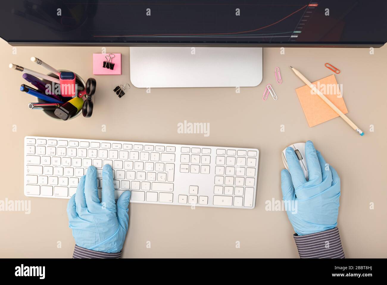 Hands with protective glove typing on keyboard computer. Worker taking ...