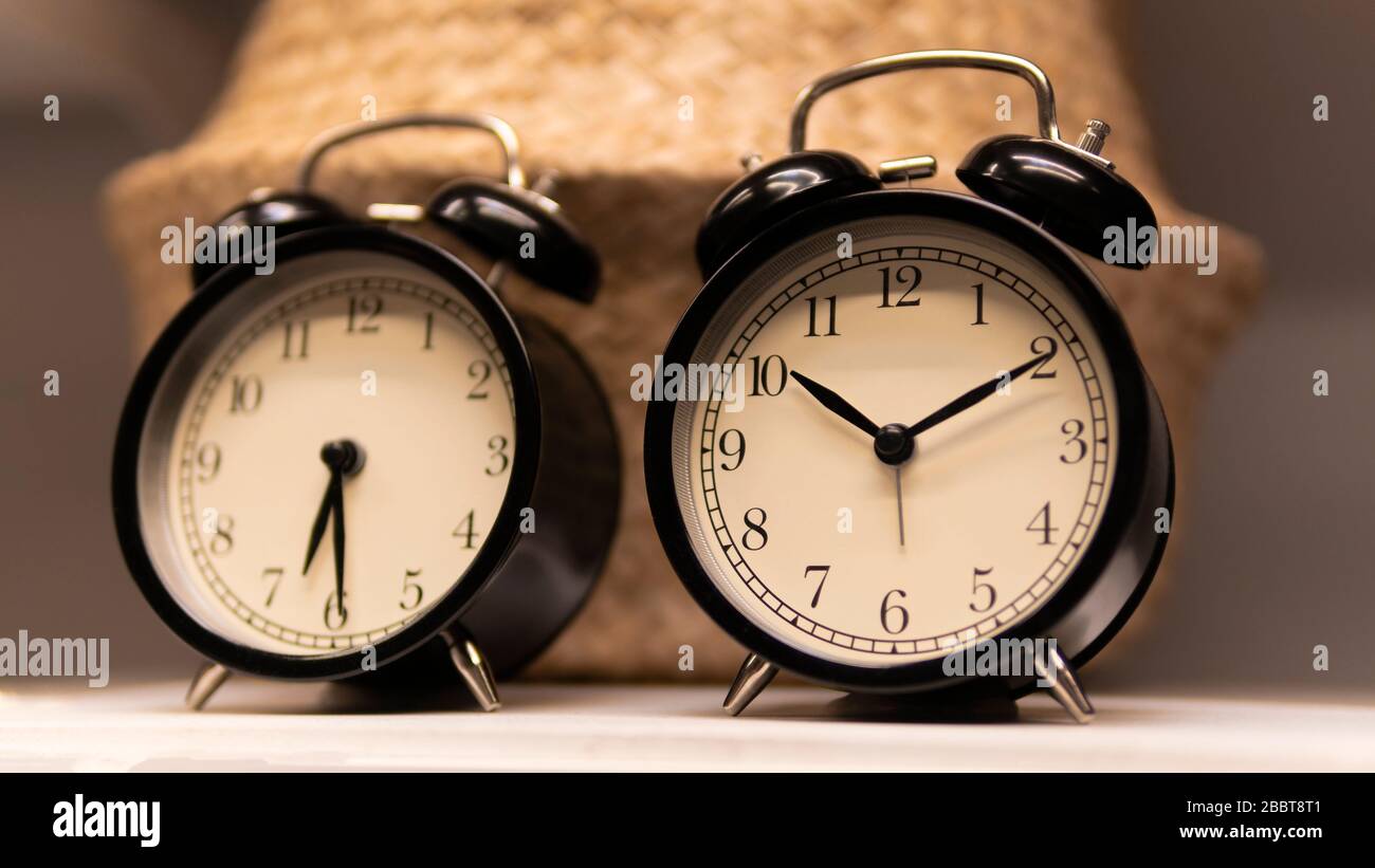 black desk clock on the shelf Stock Photo - Alamy