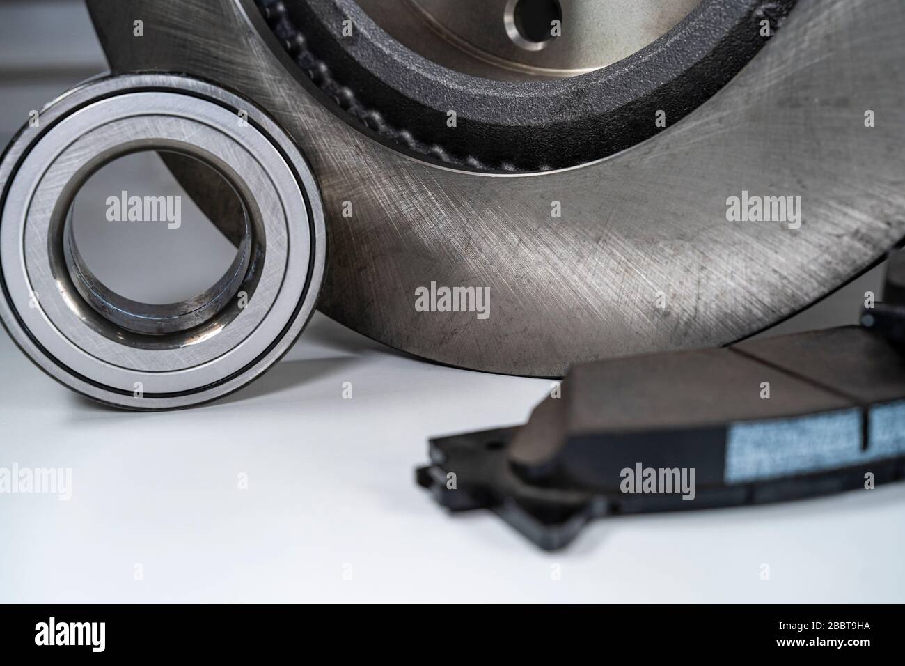 brake pads and auto parts on a white table Stock Photo - Alamy