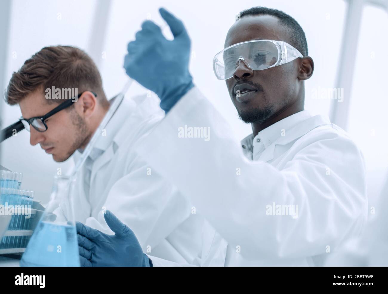 group of scientists are conducting experiments with the liquid Stock ...