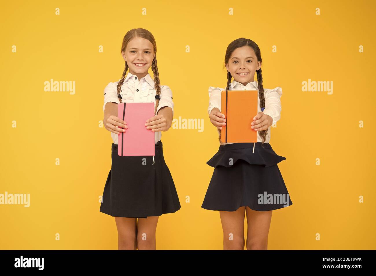 Sharing book love. Happy little girls holding books with colorful ...
