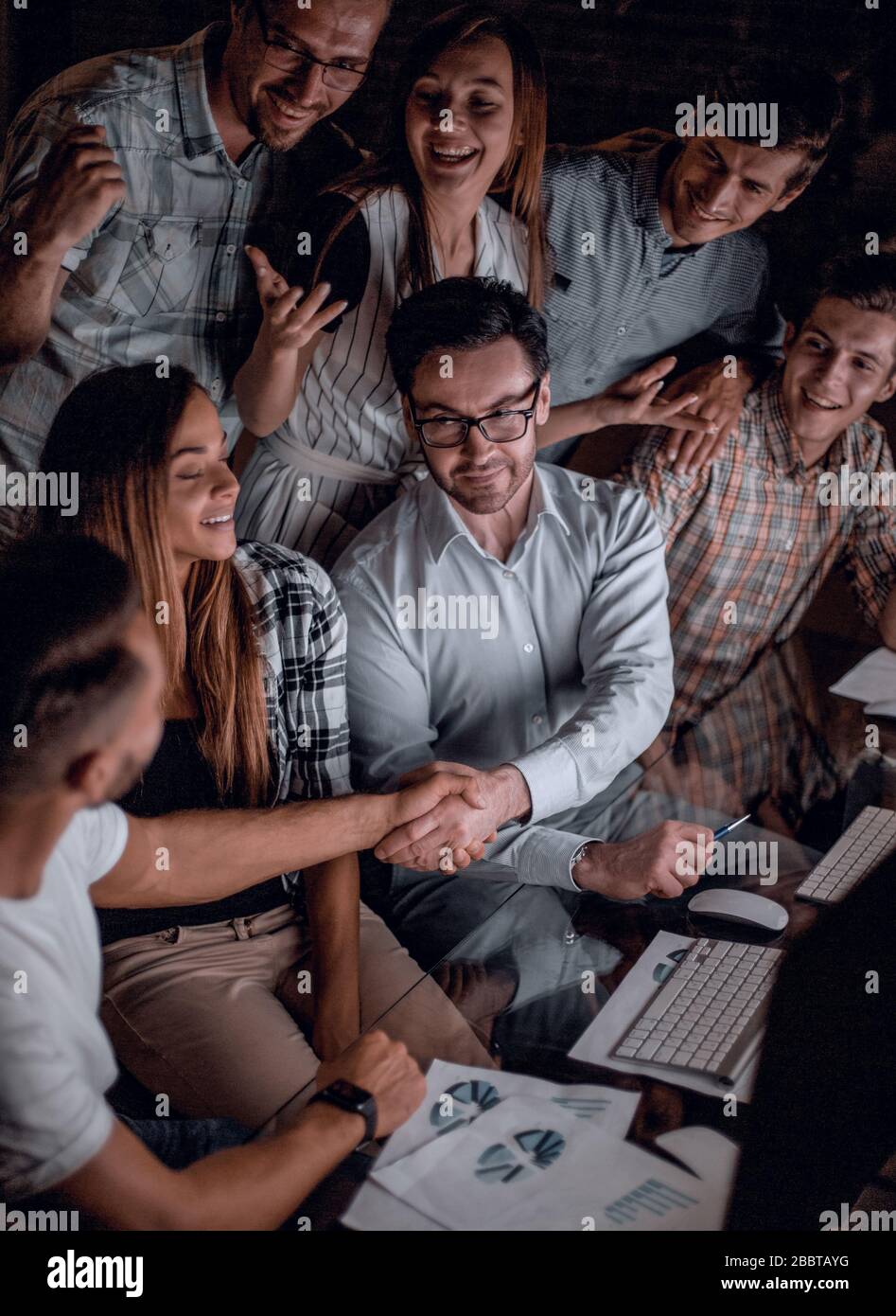 business people shaking hands over the Desk Stock Photo - Alamy