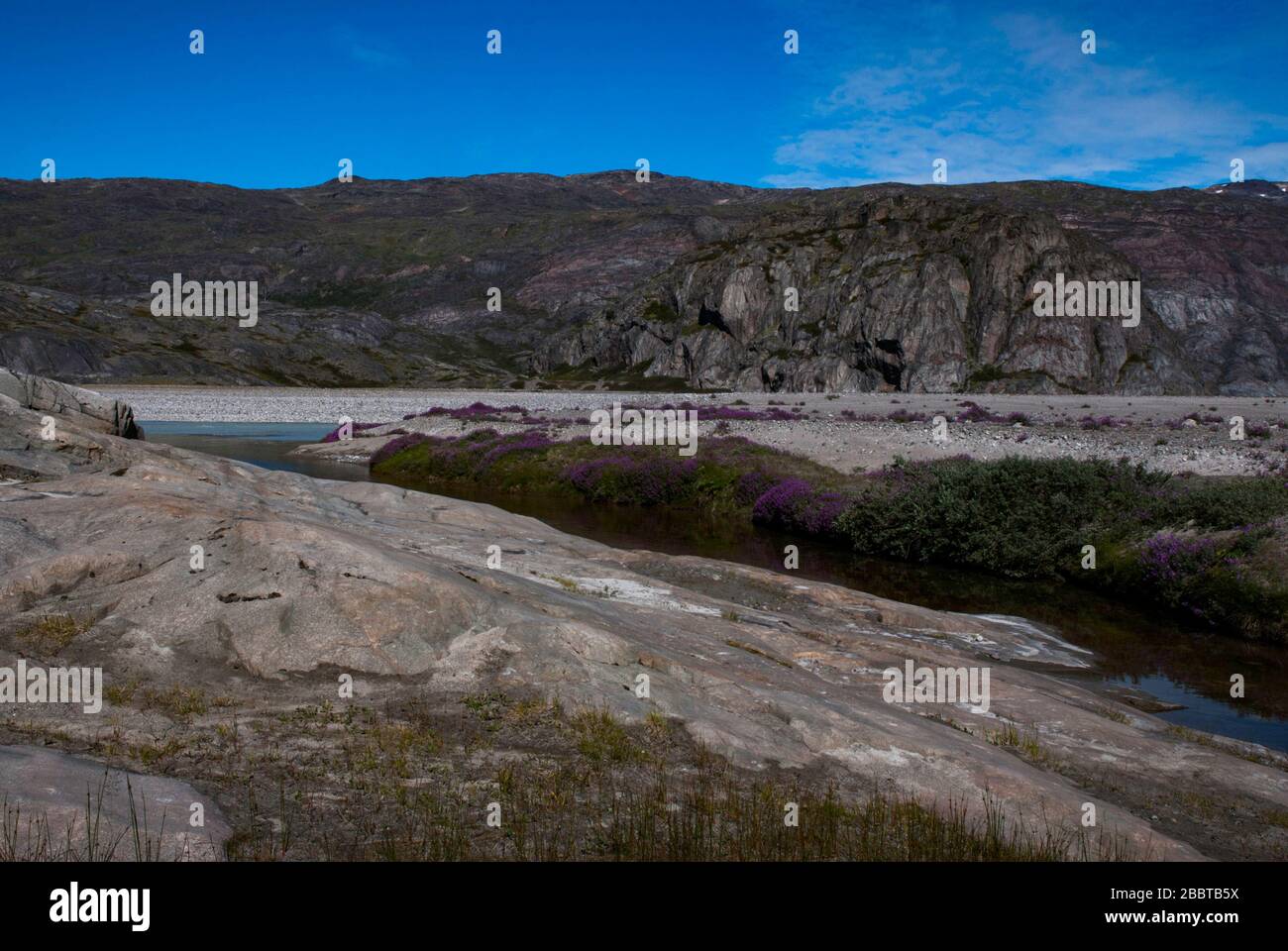 River flowing from the glacier. Mountains in the background. Greenland ...