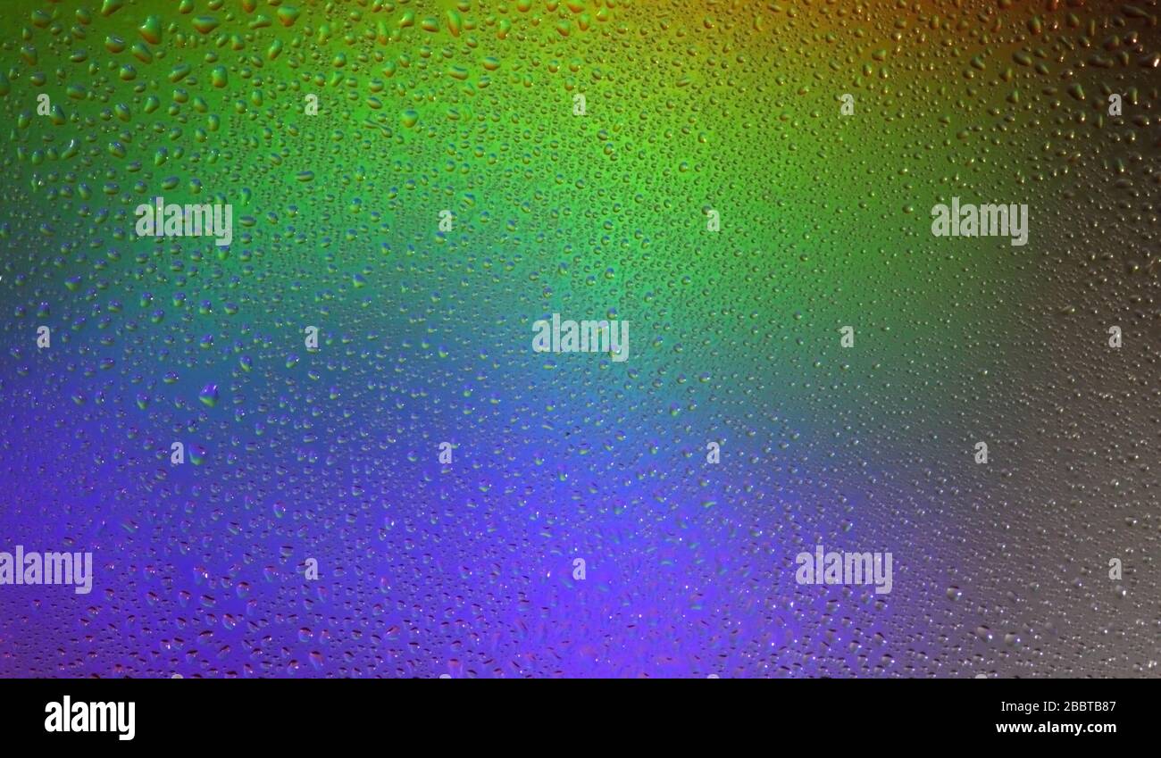 water drops on a colorful, rainbow background, background, texture ...