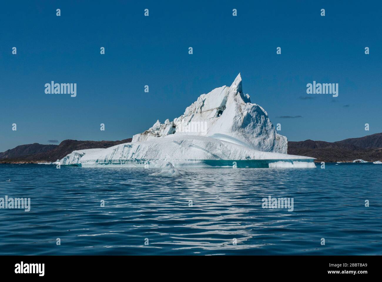 Iceberg in fjord, Greenland. Iceberg floating in the fjord water. Blue ...