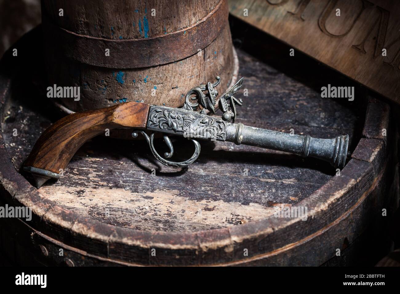 Model of the old vintage gun on wooden background Stock Photo - Alamy