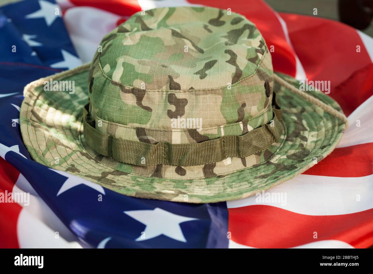US flag with camouflage cap combat hat Stock Photo - Alamy
