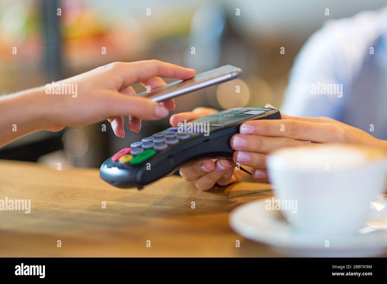Paying for coffee Stock Photo - Alamy