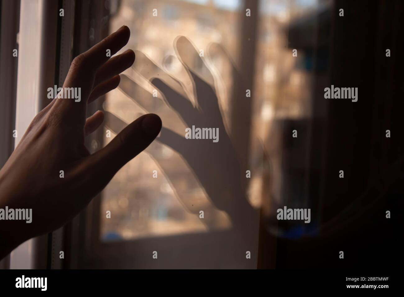 A man's hand reaches for the glass. Self isolation quarantine concept ...