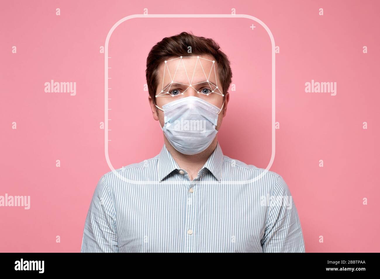 Face id verification of caucasian man on pink wall Stock Photo - Alamy