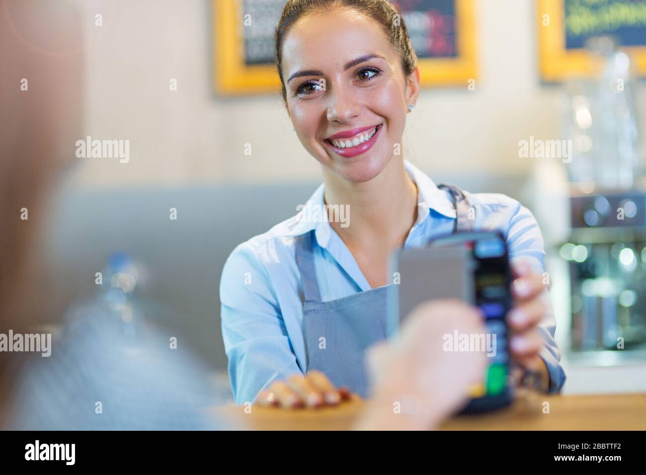 Waitress serving coffee woman hi-res stock photography and images - Alamy