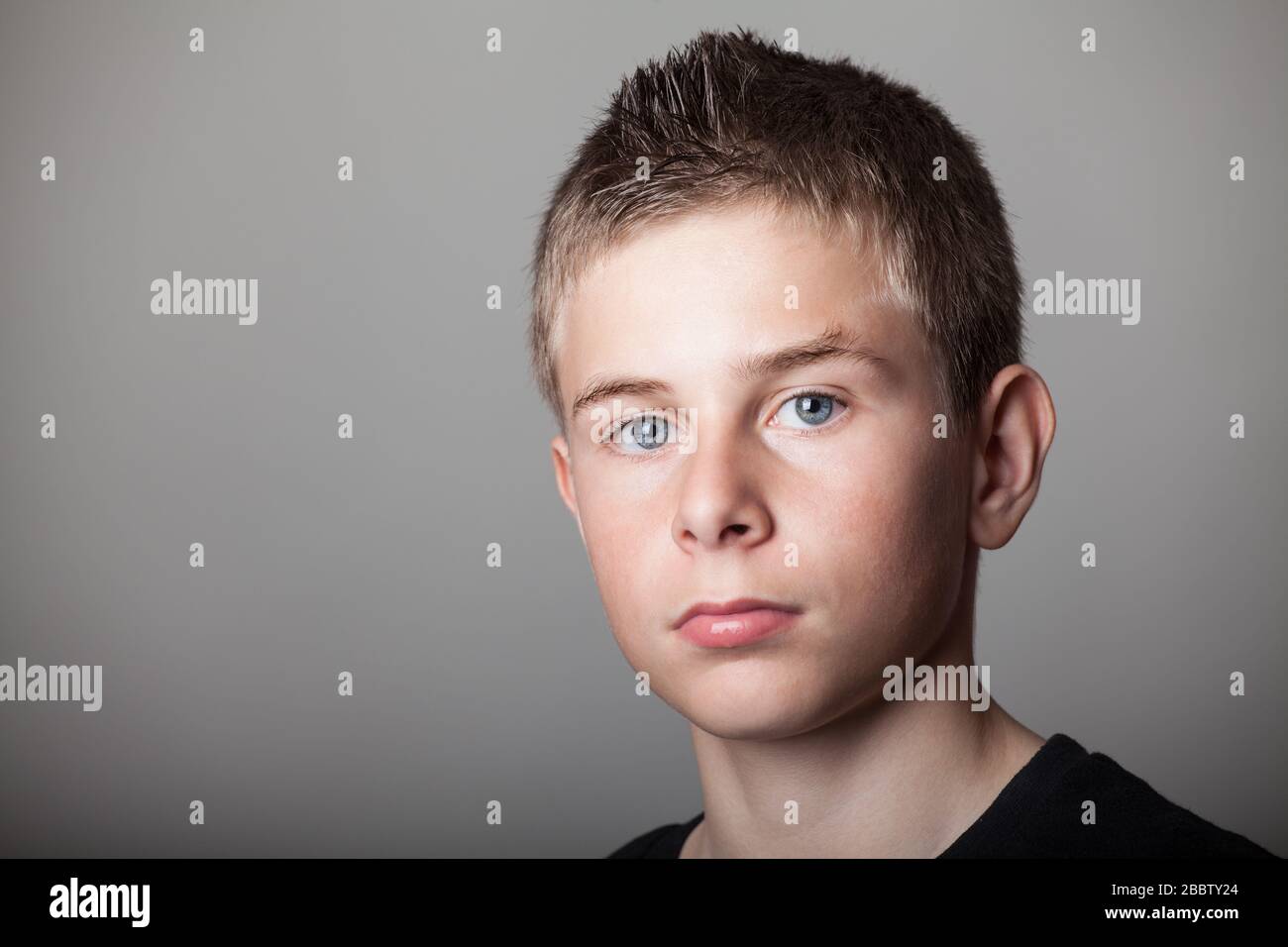 portrait of a cute young boy with gray background Stock Photo - Alamy