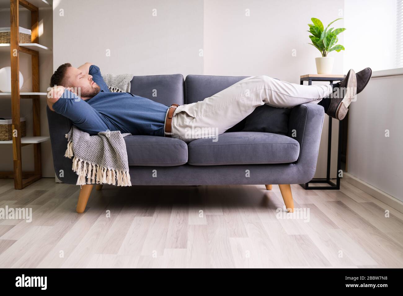 Young guy sleeping on sofa hi-res stock photography and images - Alamy