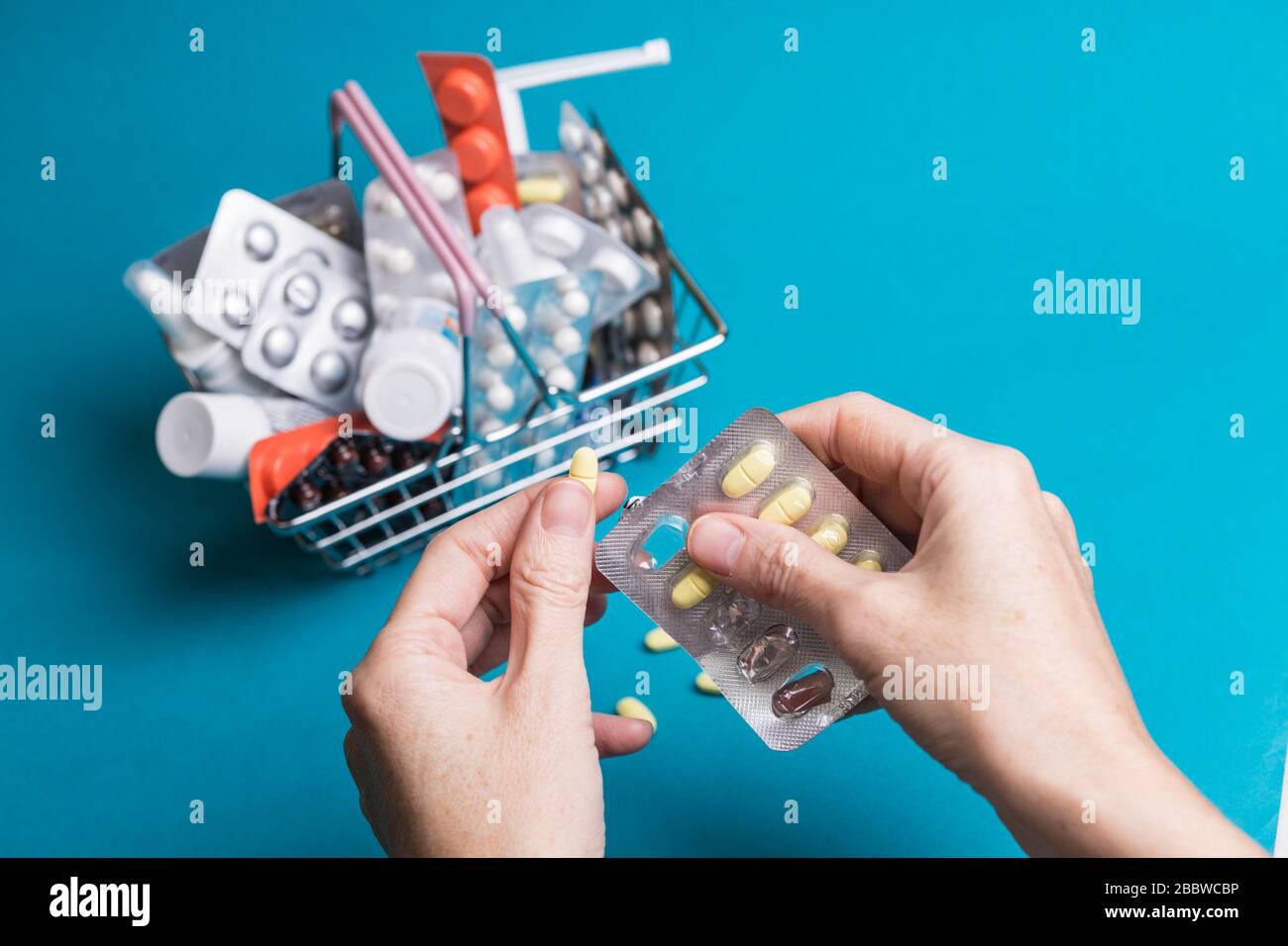 female hands with pills on the background consumer basket products with ...