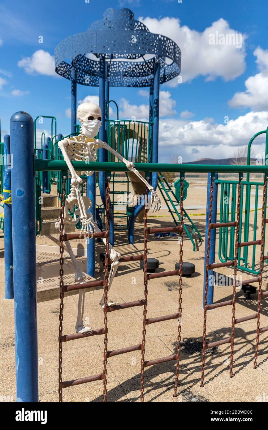Skeleton climbing on ladder toy at an empty closed park on a nice day ...