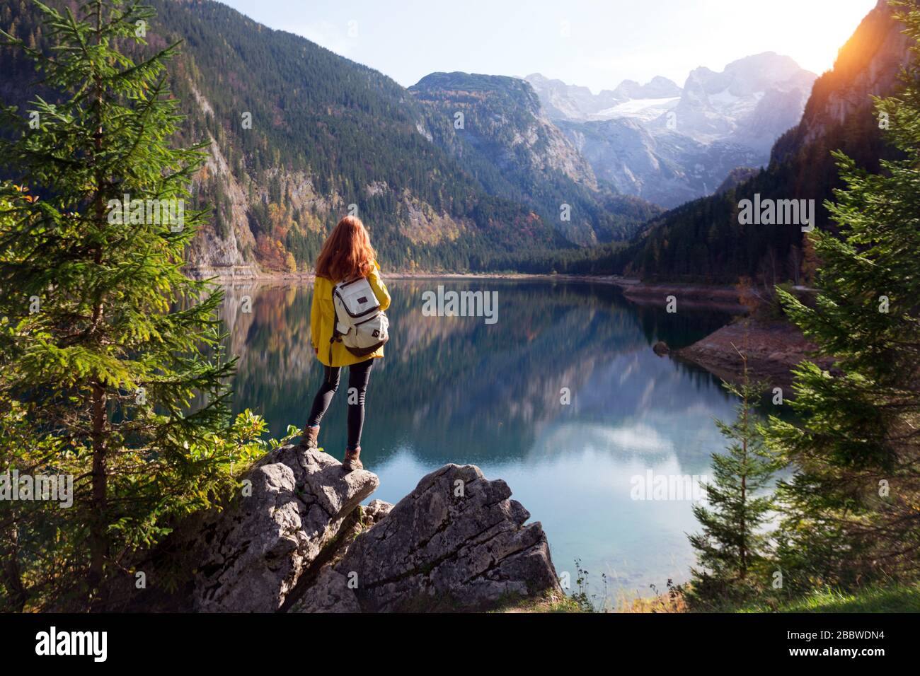 mountain trip. happy girl on the background of a mountain lake and ...