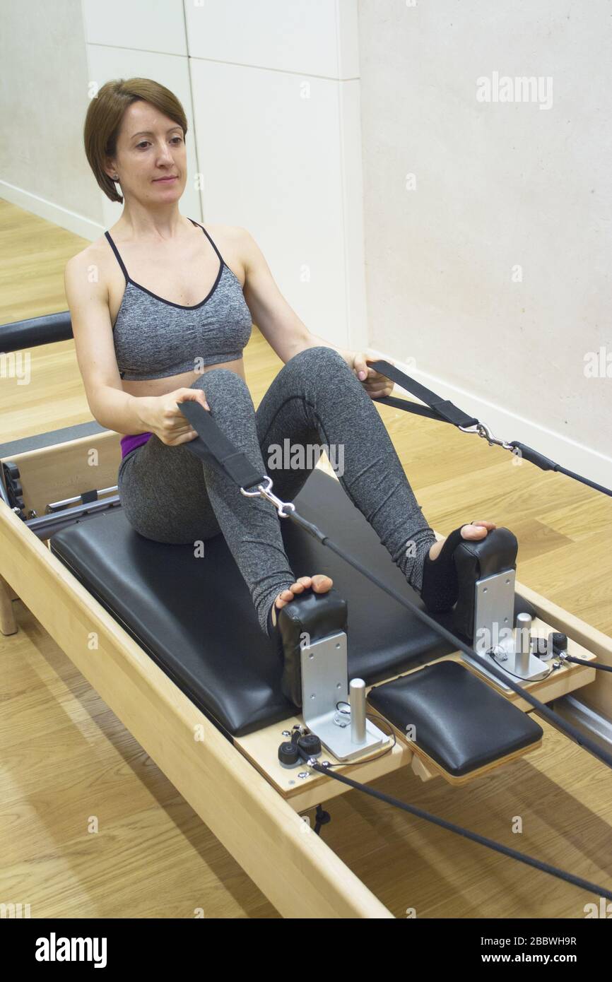 Woman doing pilates machine exercises Stock Photo - Alamy