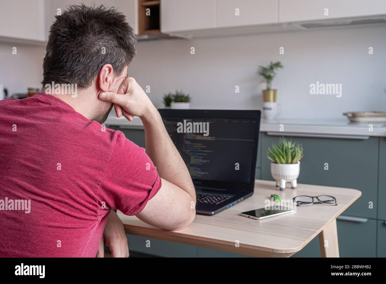 man working in home office on his computer Stock Photo - Alamy