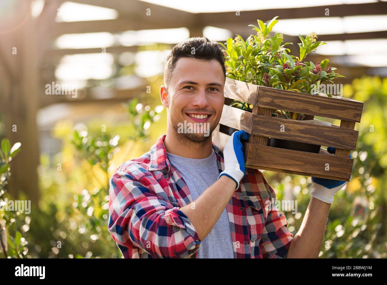 Smiling employees in garden center Stock Photo - Alamy